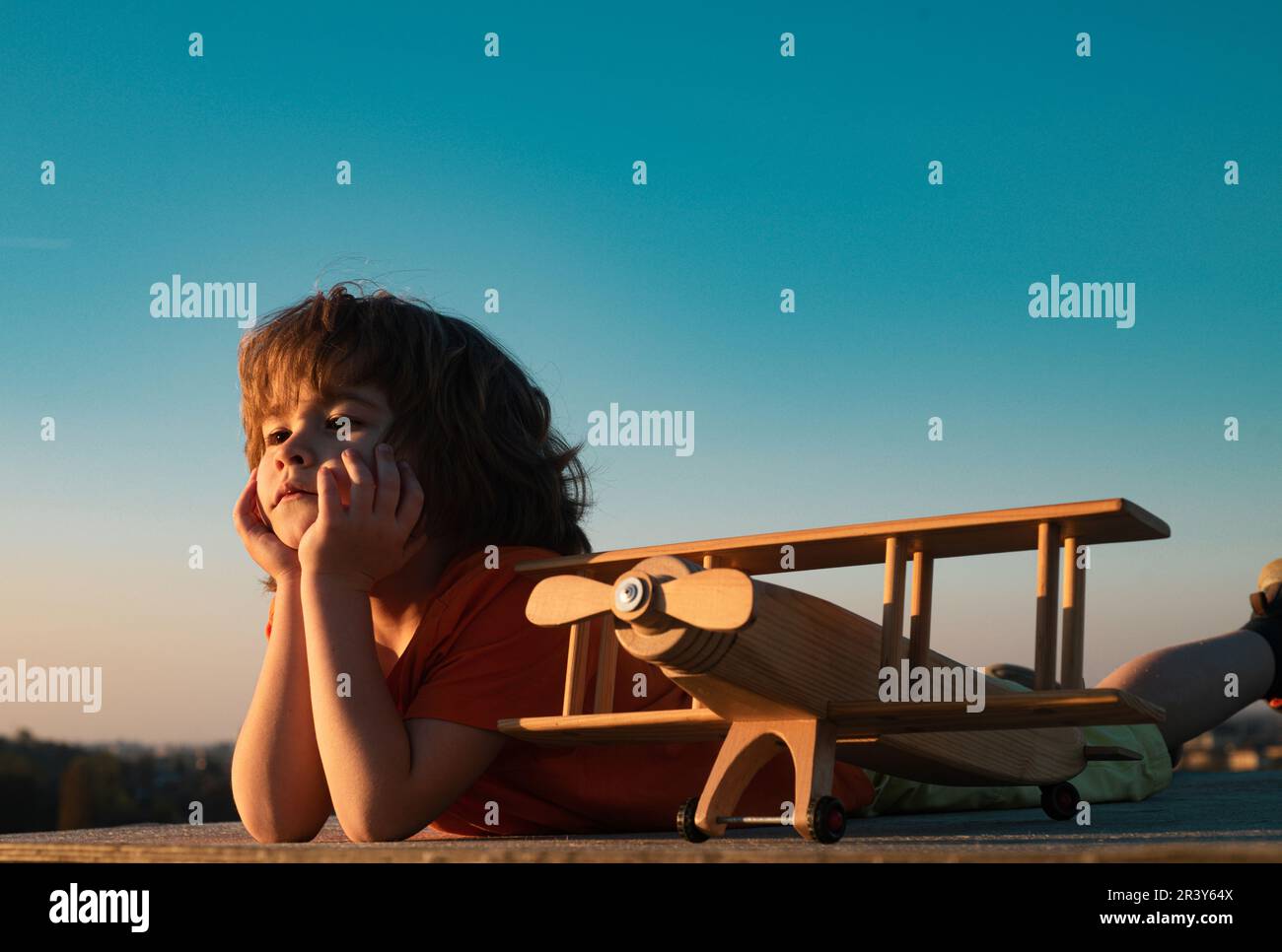 Little boy 7 year old with wooden plane, boy wants to become pilot and ...