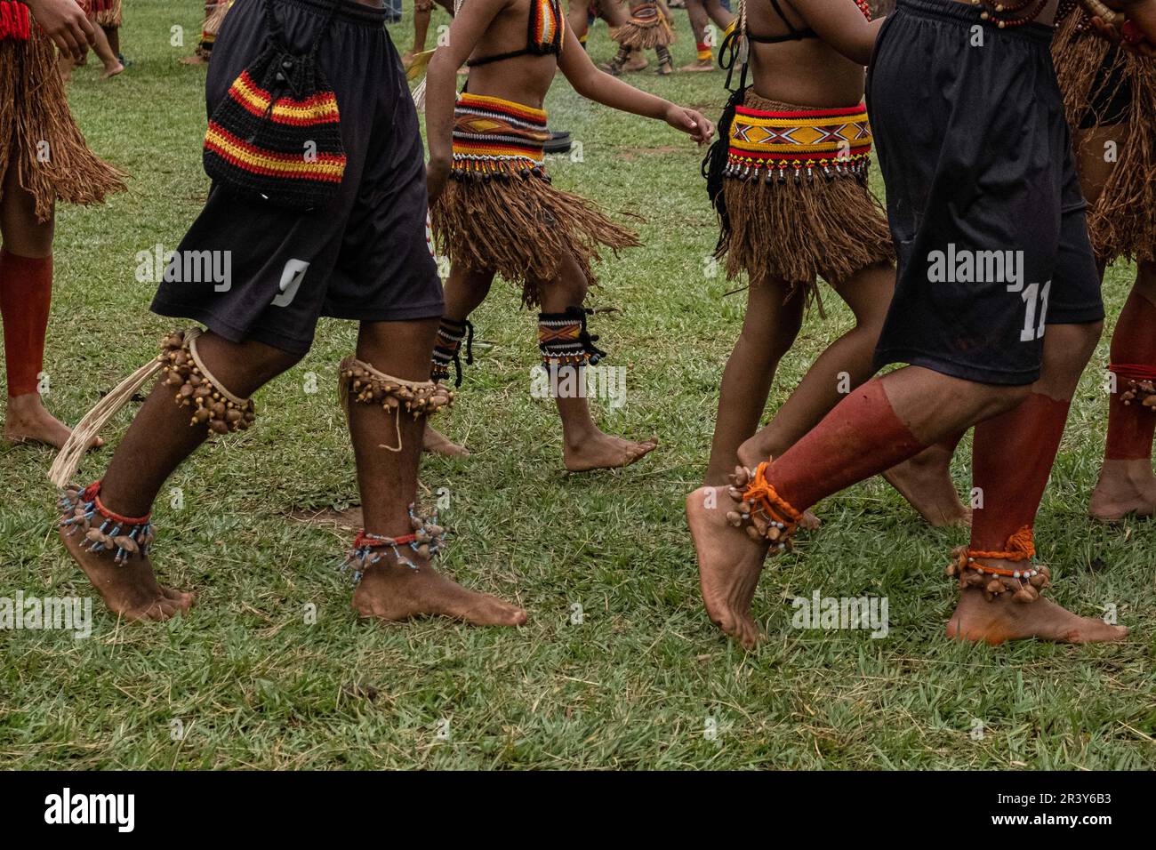 Details of legs and feet of a group of indigenous people wearing ...