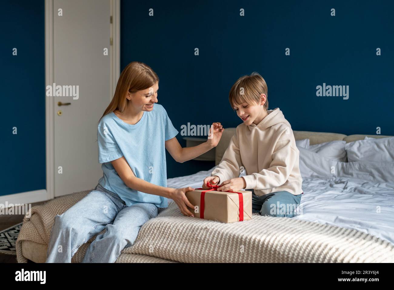 Happy kid son unwrapping gift box feeling excited getting present from ...