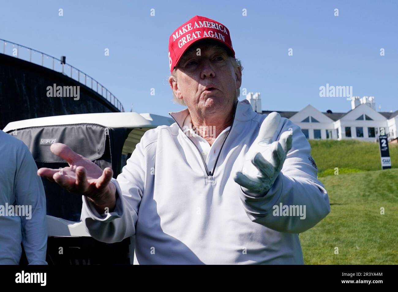 Former President Donald Trump talks to reporters during the LIV Golf ...