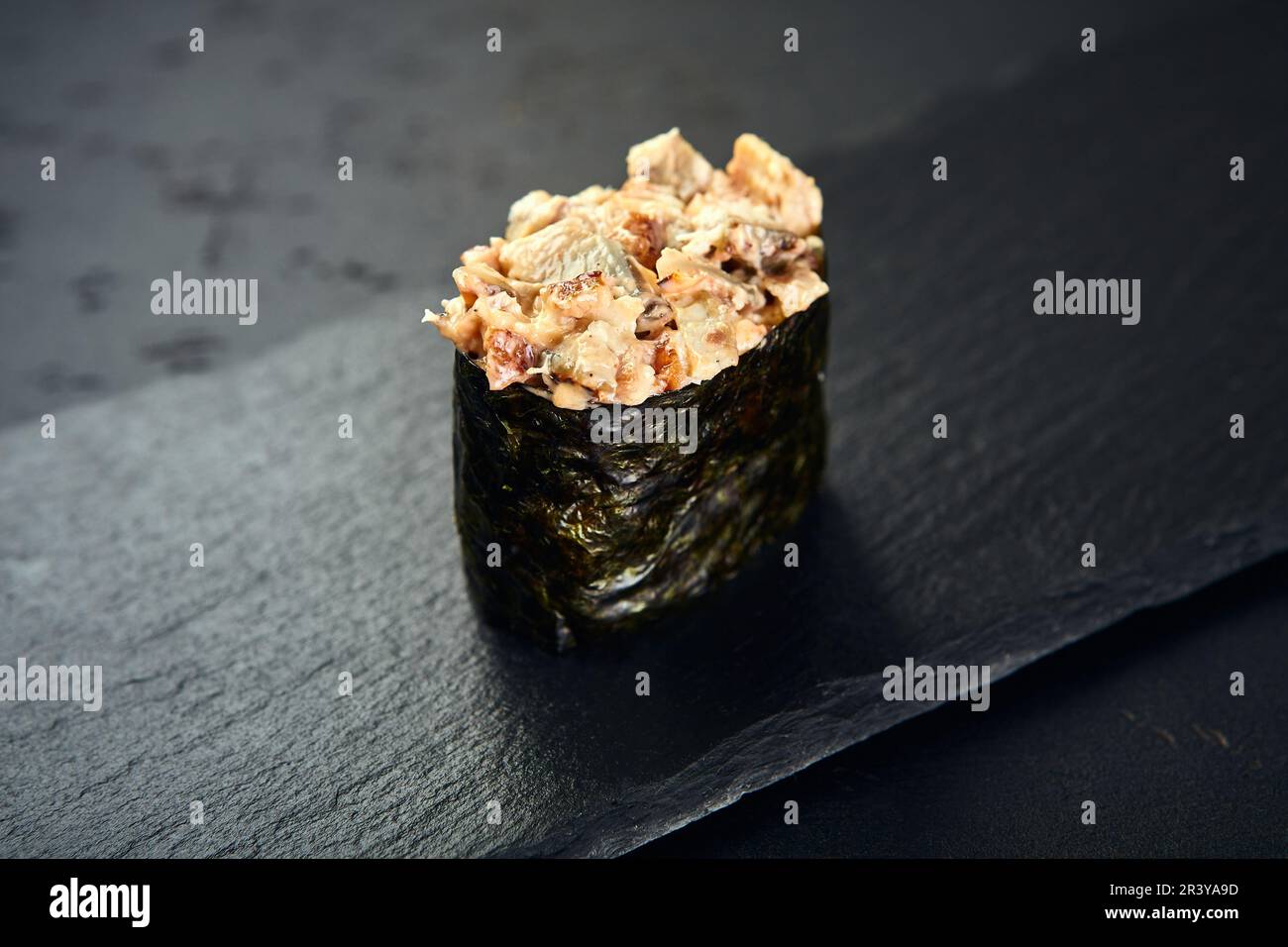 Japanese sushi gunkan with eel. Gunkan with rice and eel wrapped in nori seaweed. Pan-Asian dish ...