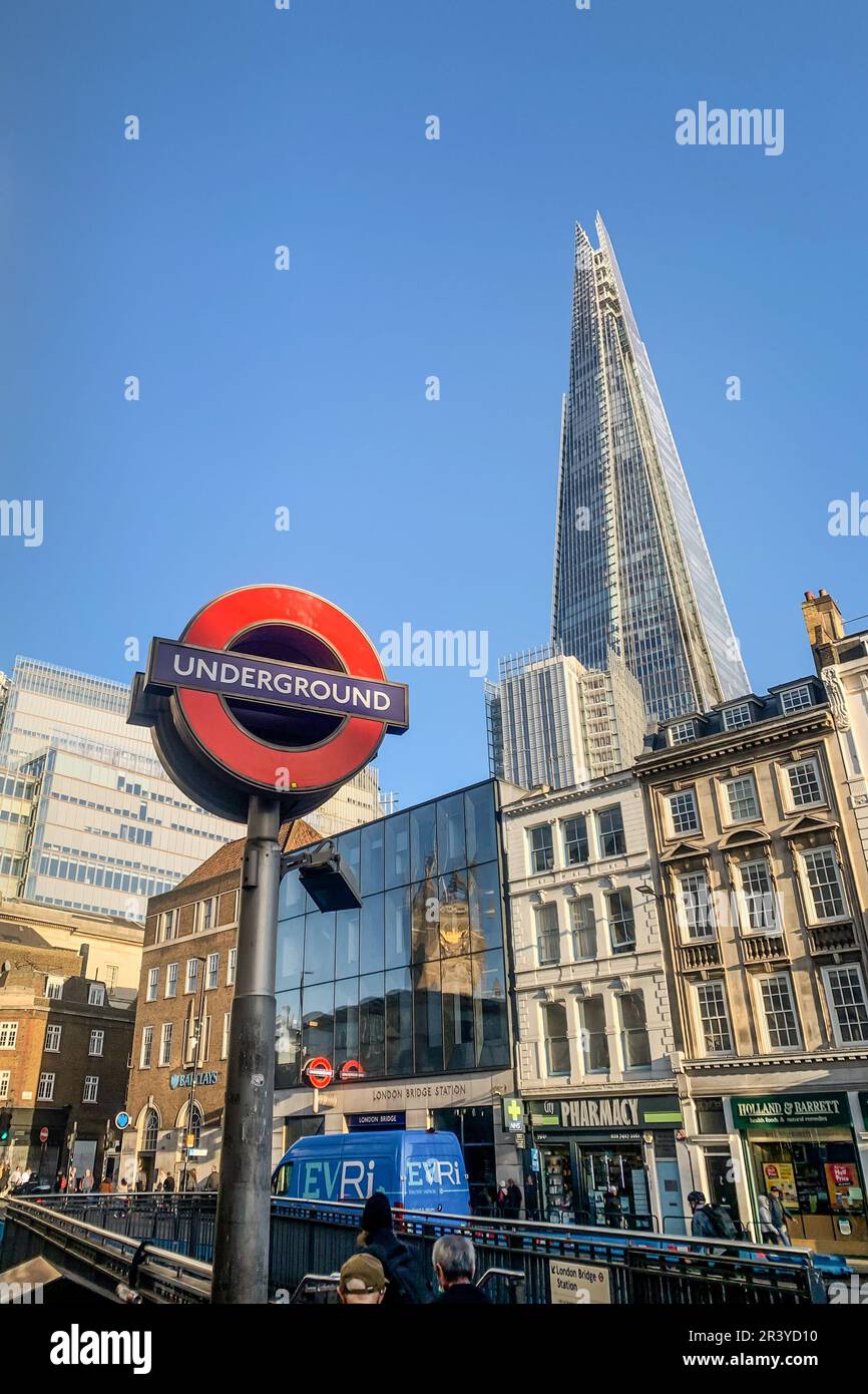 Underground sign and The Shard buiding in a street, London cityscape ...