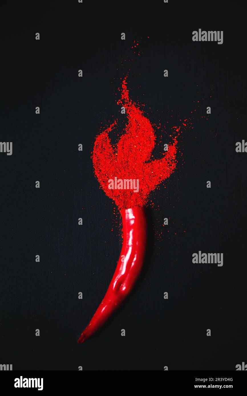 Flaming Pepper. Chili pepper turns into powder. Dark background Stock ...