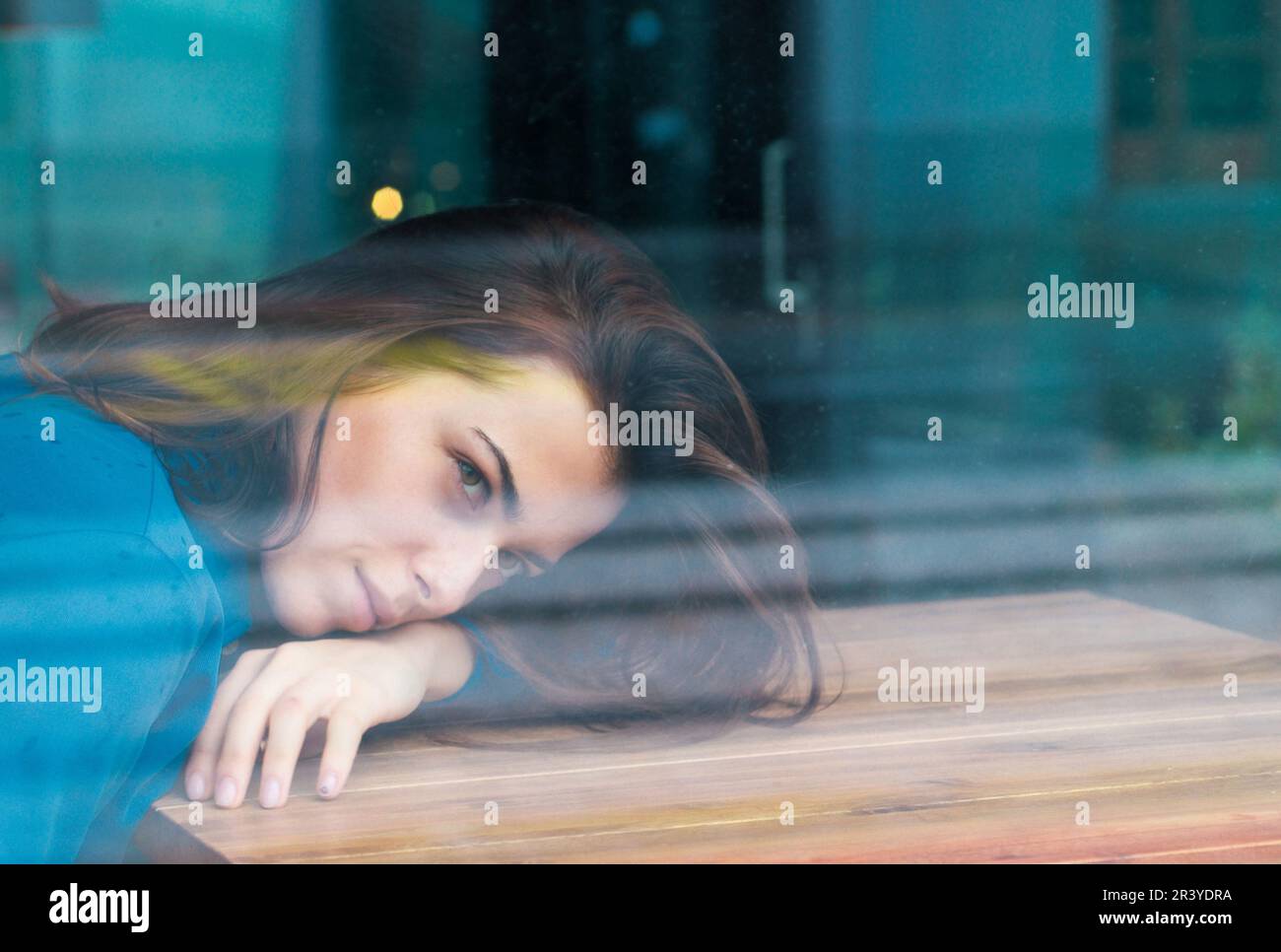 Girl in the window watching. Woman at a cafe while gazing through the ...