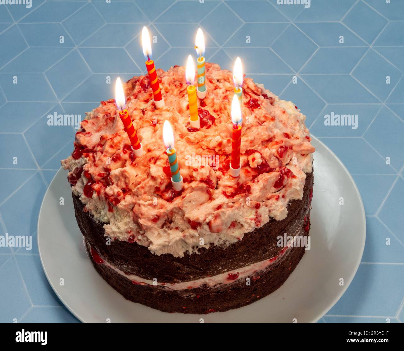 Chocolate & raspberry birthday layer cake with candles Stock Photo - Alamy