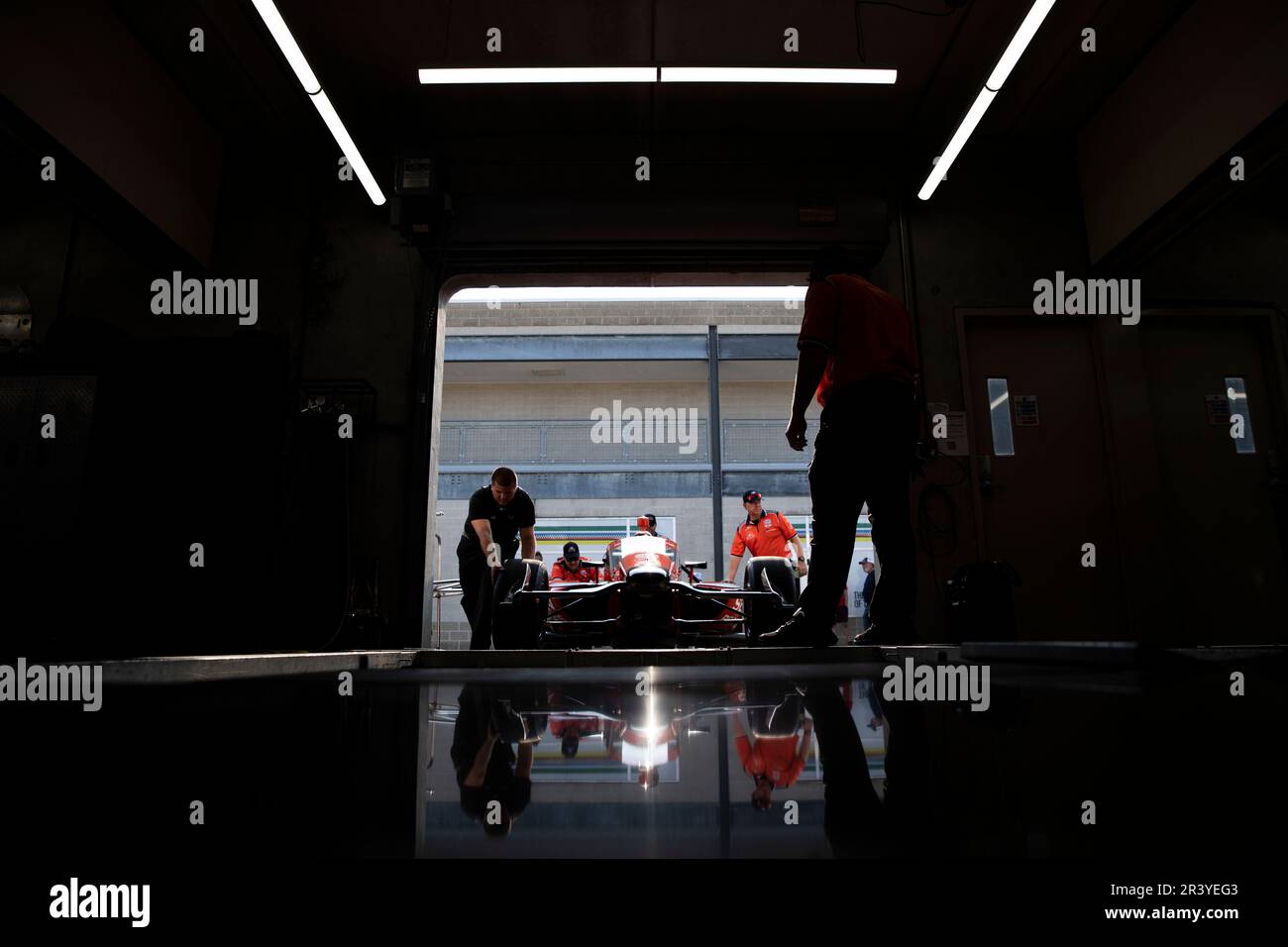 The crew of AJ Foyt racing work on the car following a practice session ...