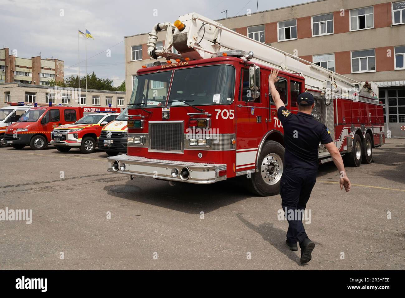 Ukrainian firefighters examine a US fire truck, a gift of the Illinois ...