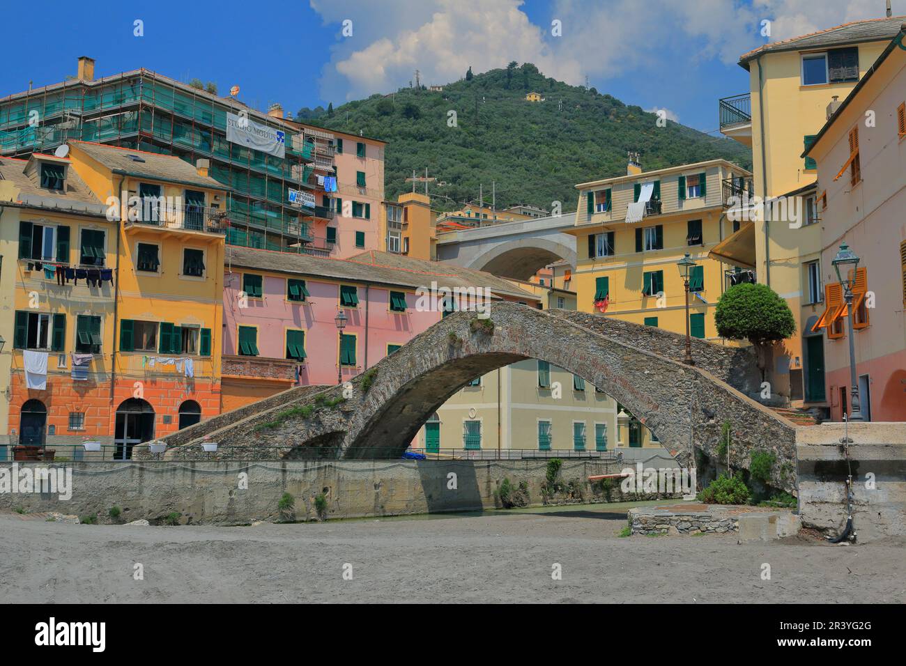 Two bridges: an old humpback and a modern one. View from the beach of ...
