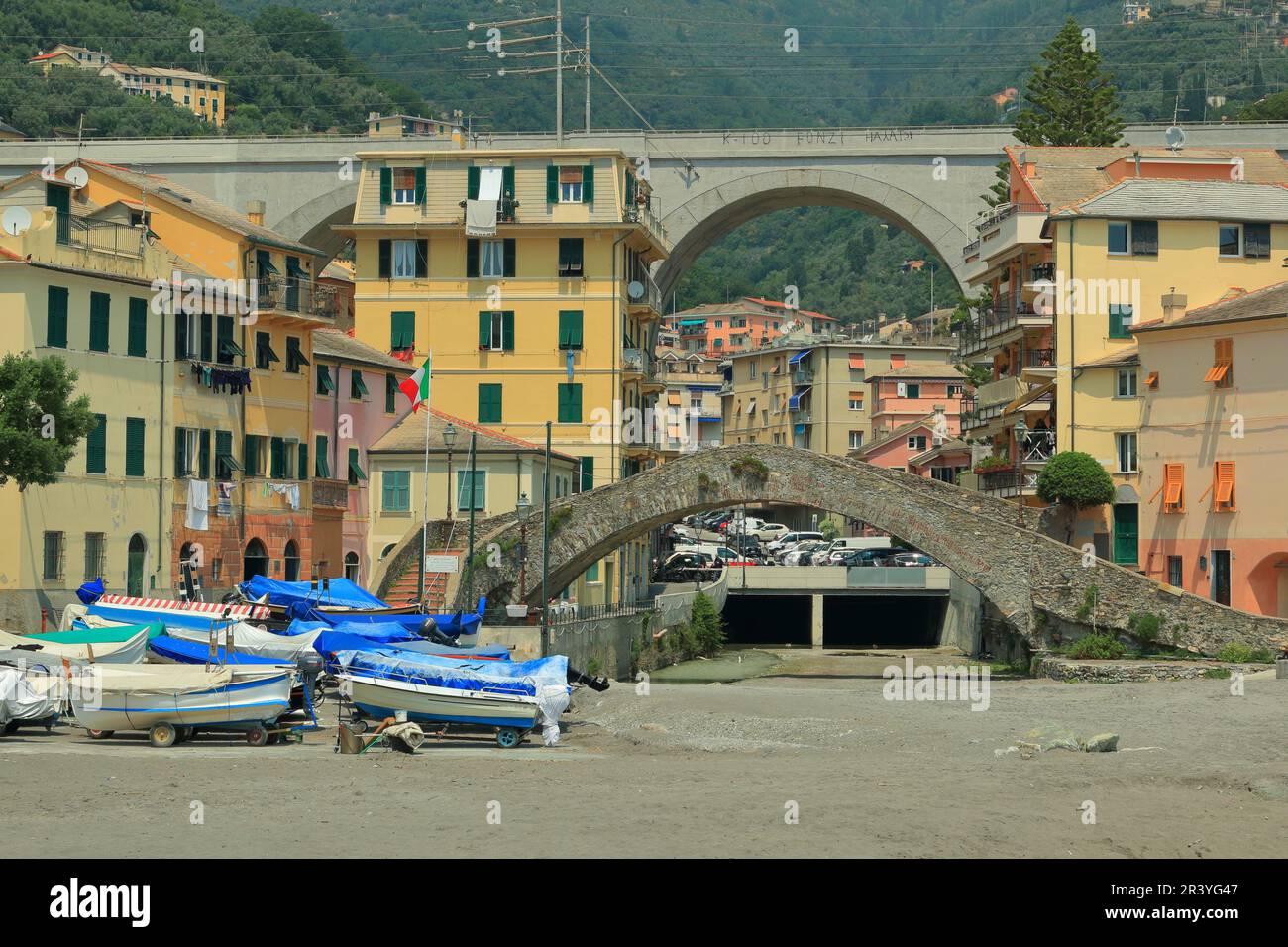 Two bridges: an old humpback and a modern one. View from the beach of ...