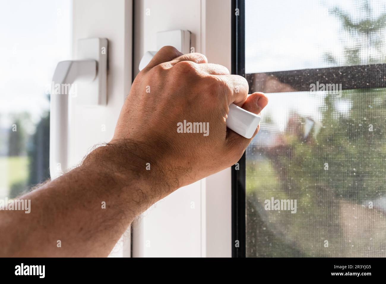 Male hand opening modern plastic window on a sunny day, close up photo ...
