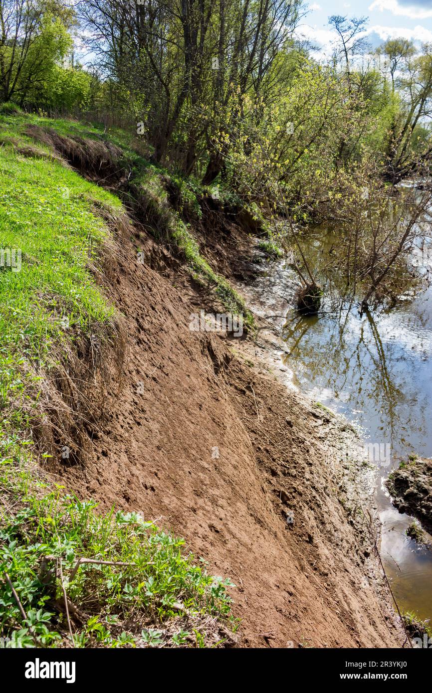 View of the landslide of the clay bank on the river Stock Photo - Alamy
