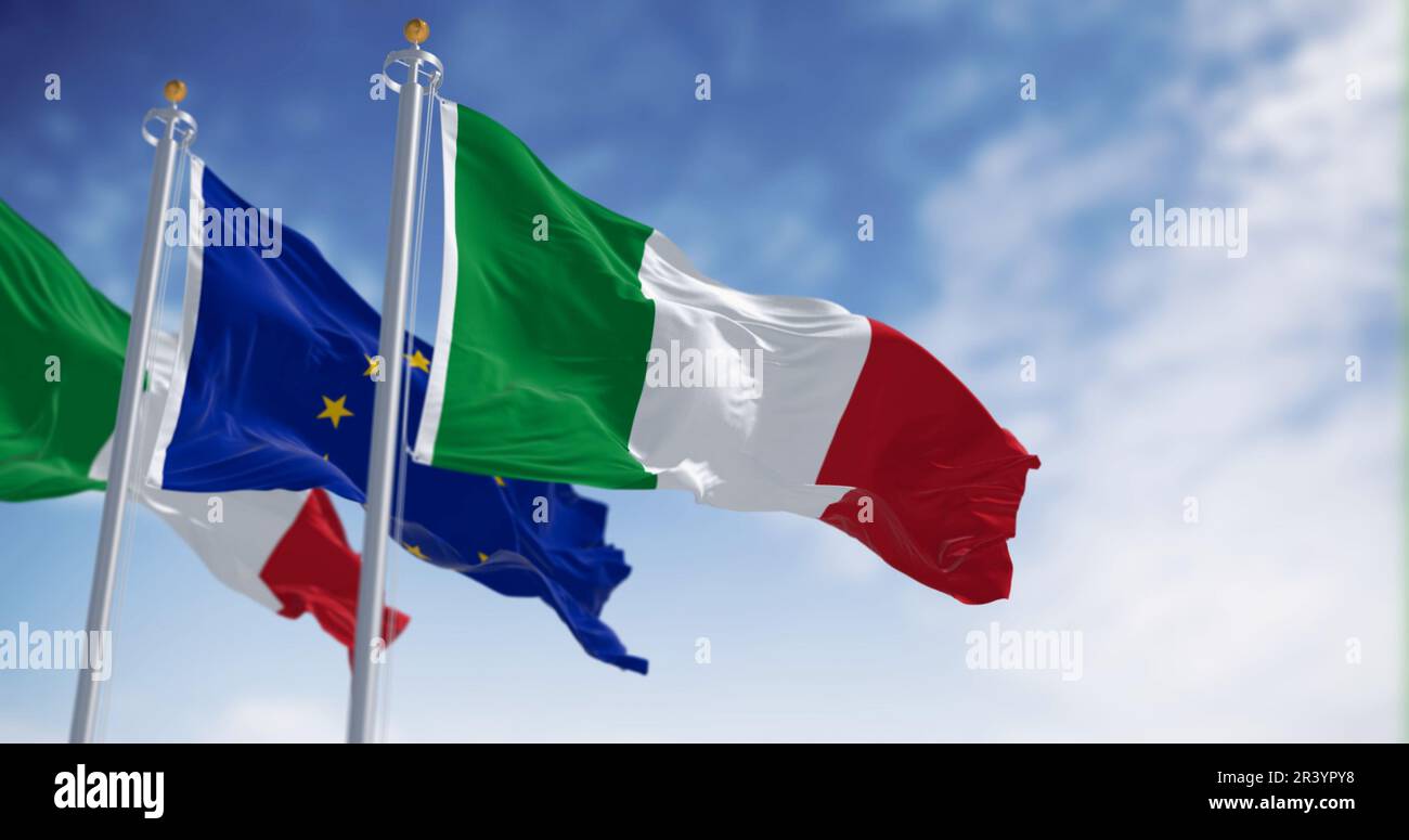 the flags of Italy and the European Union waving in the wind on a sunny ...