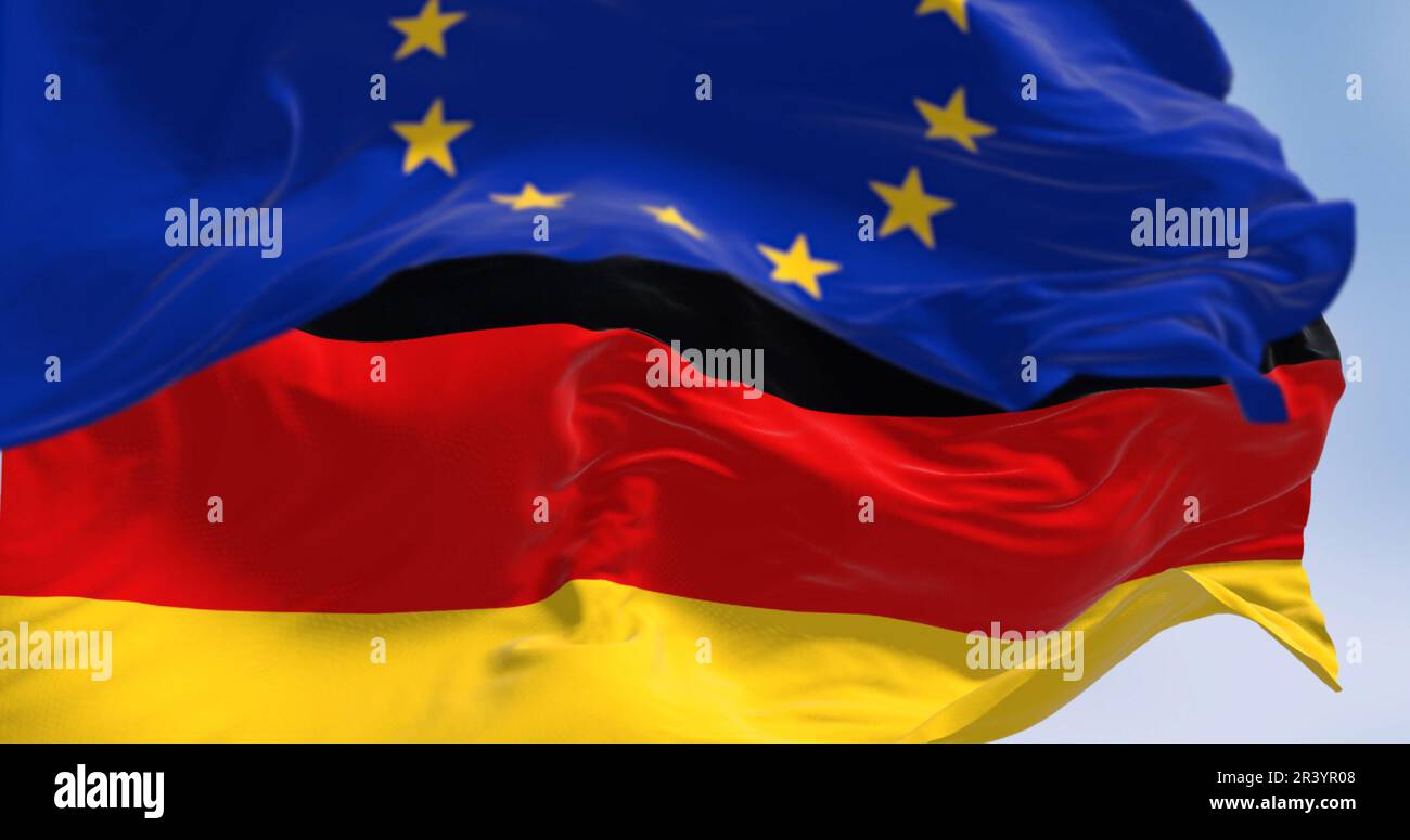 The flags of Germany and the European Union waving in the wind on a ...
