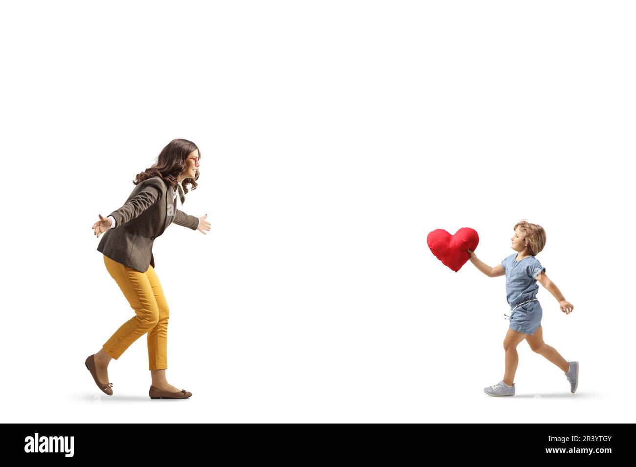 Little girl holding a red heart and running towards a young woman ...