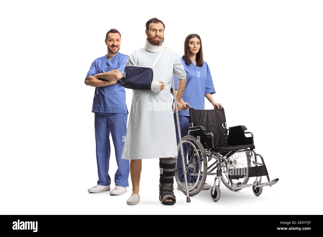 Patient in a hospital gown with a broken leg and arm standing with a ...