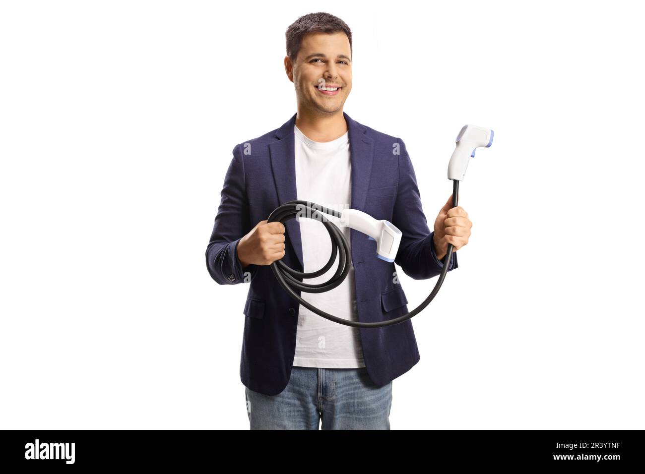 Smiling man holding a cable for electrical vehicle charging isolated on ...