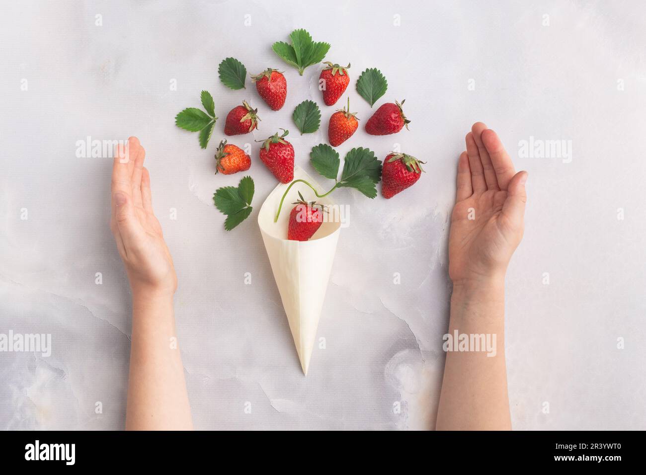 strawberries with green leaves in cornet concept Stock Photo - Alamy