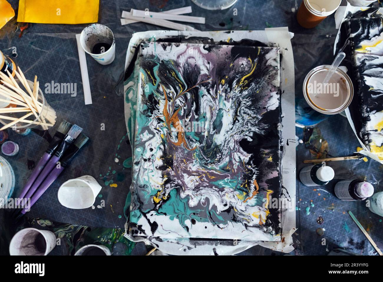 Abstract painting is made in the technique of painting with liquid ...