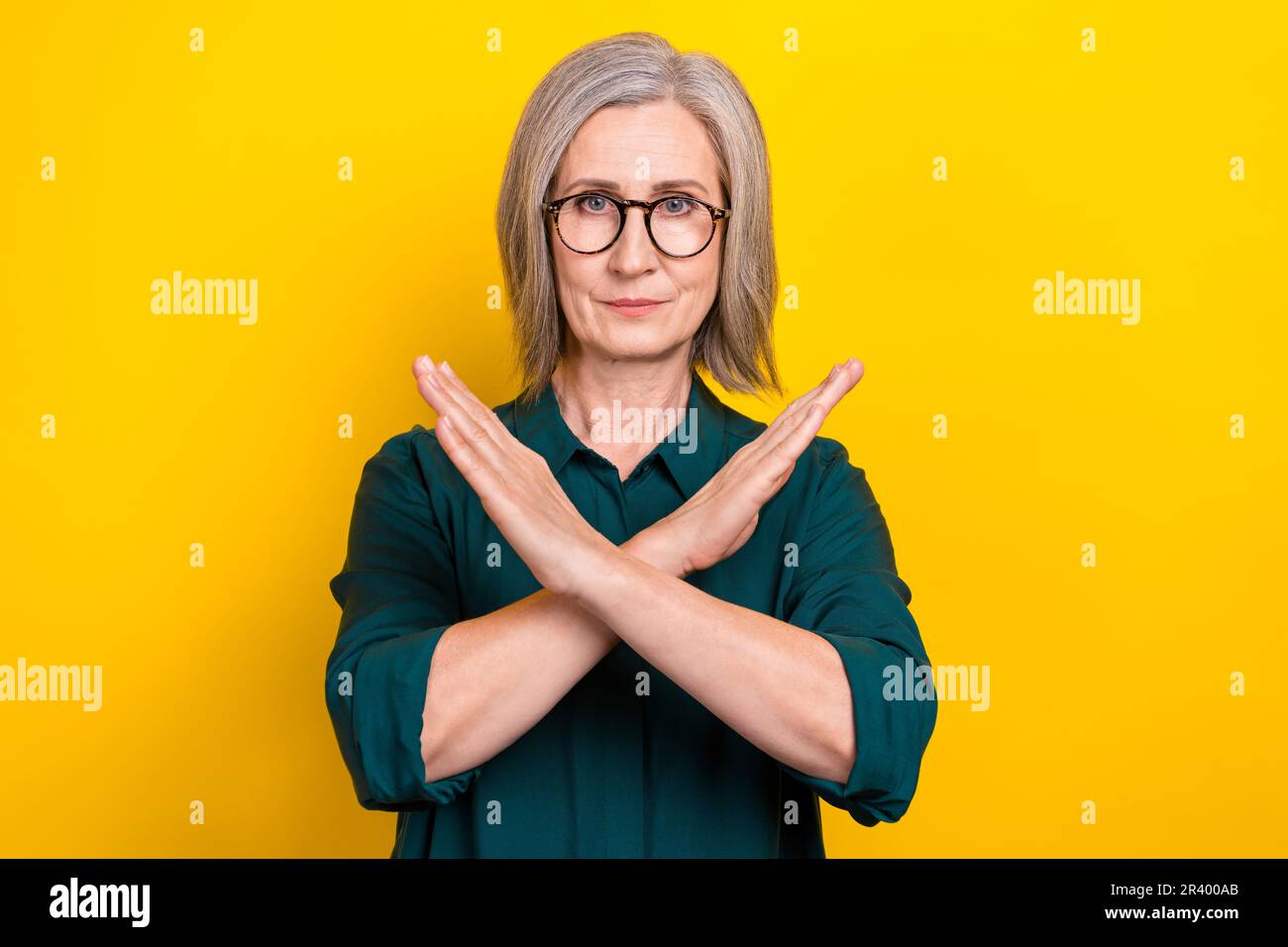 Photo of strict aged person crossed arms demonstrate stop enough symbol ...