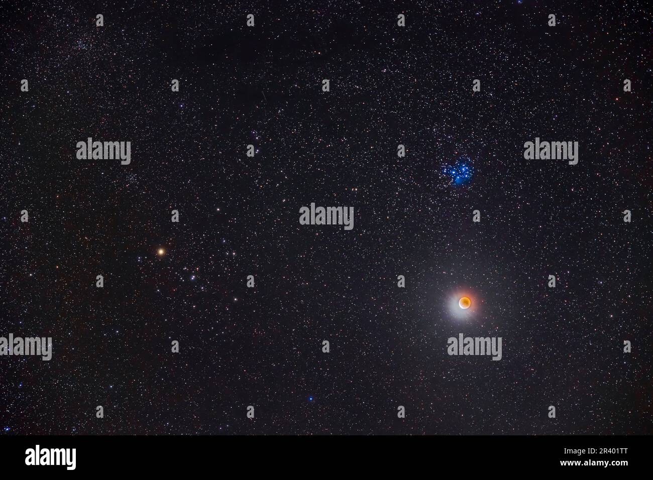 Partial eclipse of the moon below the Pleiades star cluster in Taurus ...