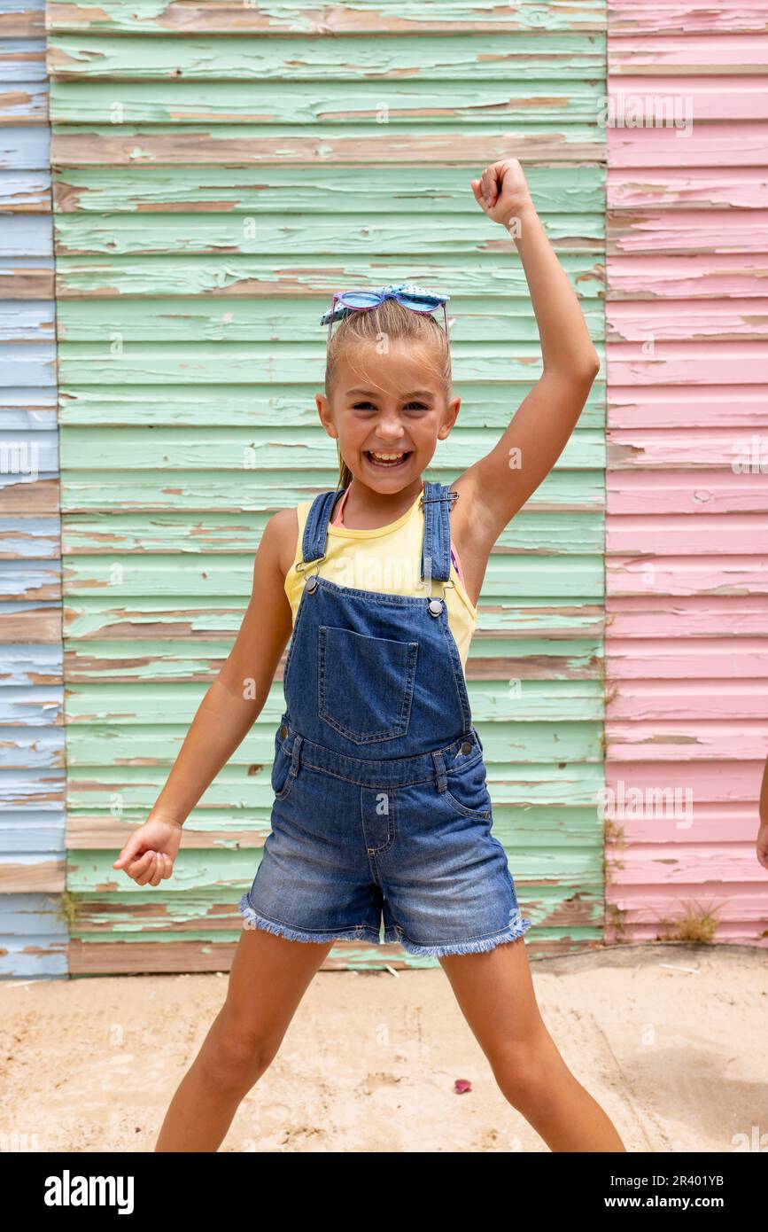 Portrait of happy biracial girl smiling over colorful wall Stock Photo ...