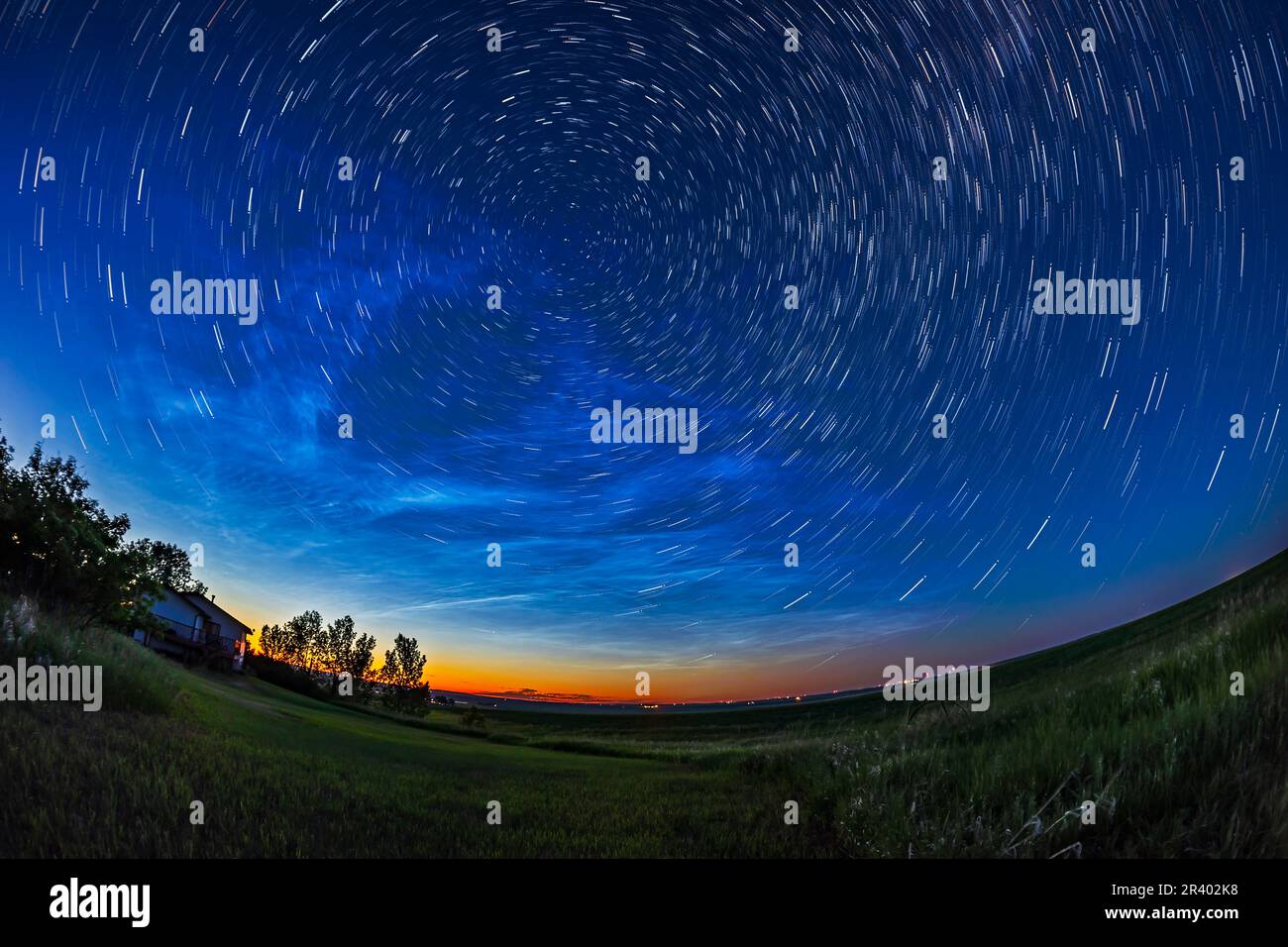 Noctilucent clouds blended with a star trail sequence of the ...