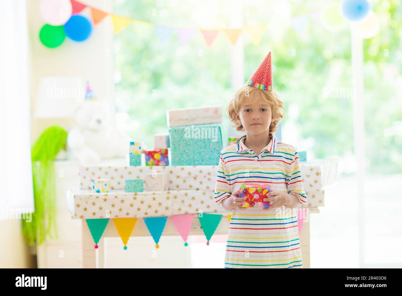 Kids birthday party. Children play with balloons and open presents ...
