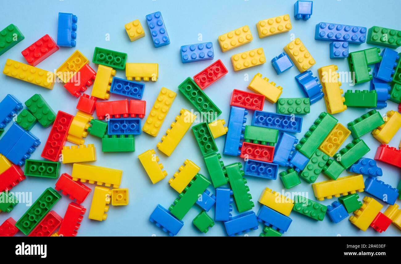 Multi-colored plastic cubes of a children's designer on a blue ...