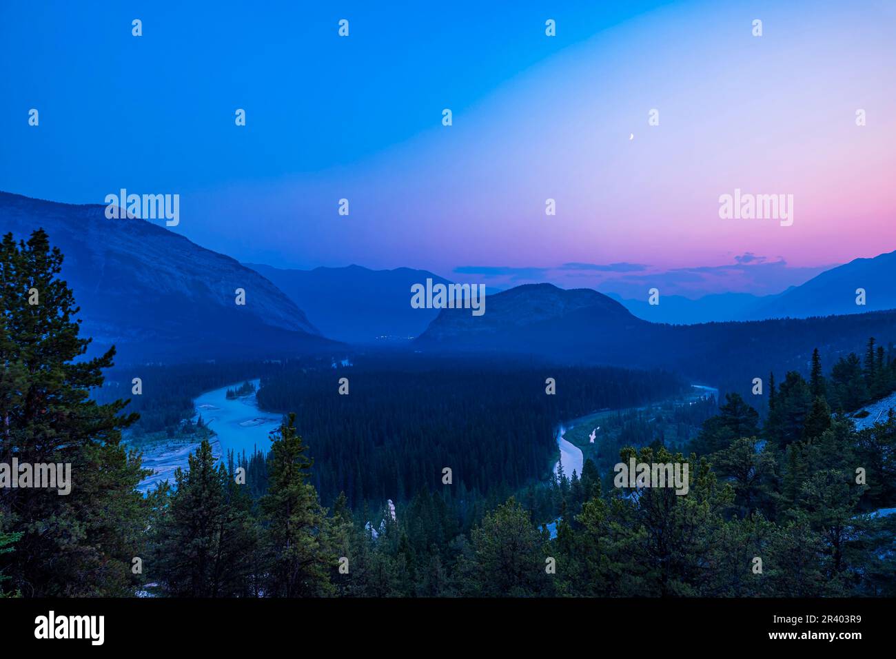 Smoky waxing crescent moon over the Bow Valley in Banff, Alberta ...
