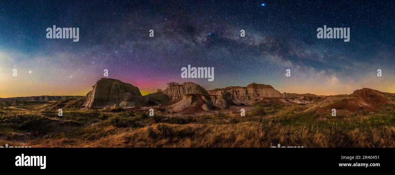 Panorama of the Milky Way arching over the badlands formations at ...