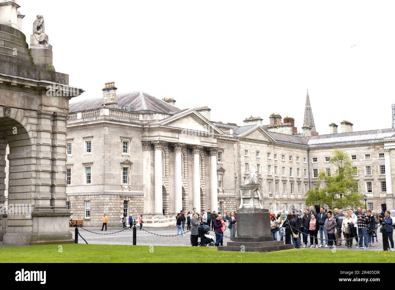 A group gathered for a tour on the grounds of Trinity College in Dublin ...