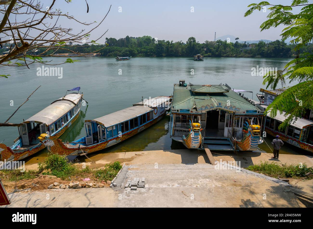 Tourist dragon boats moored by the Thien Mu Pagoda on the Perfume River ...