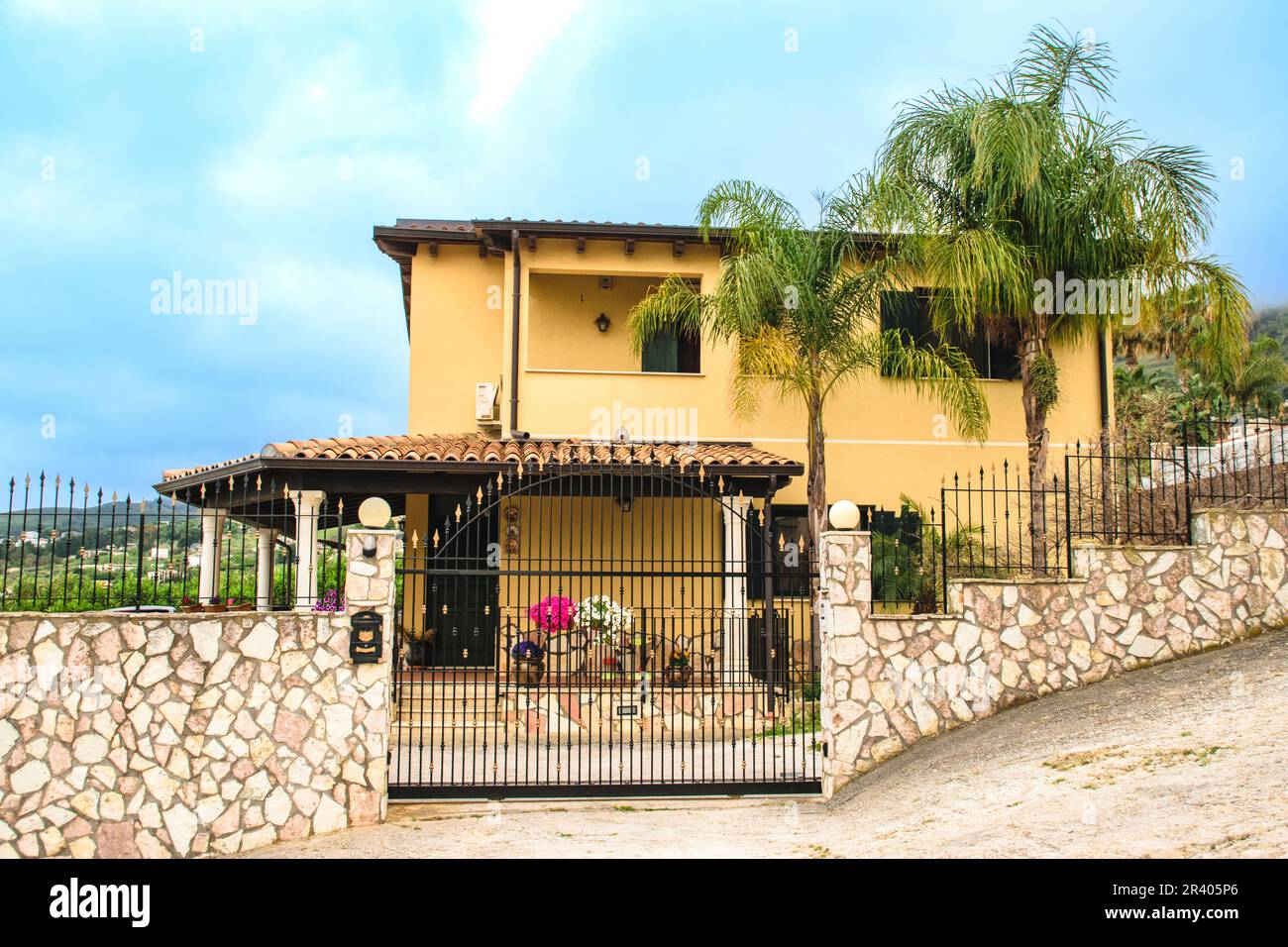 Exterior of beautiful typical Sicilian villa house with palm trees and ...