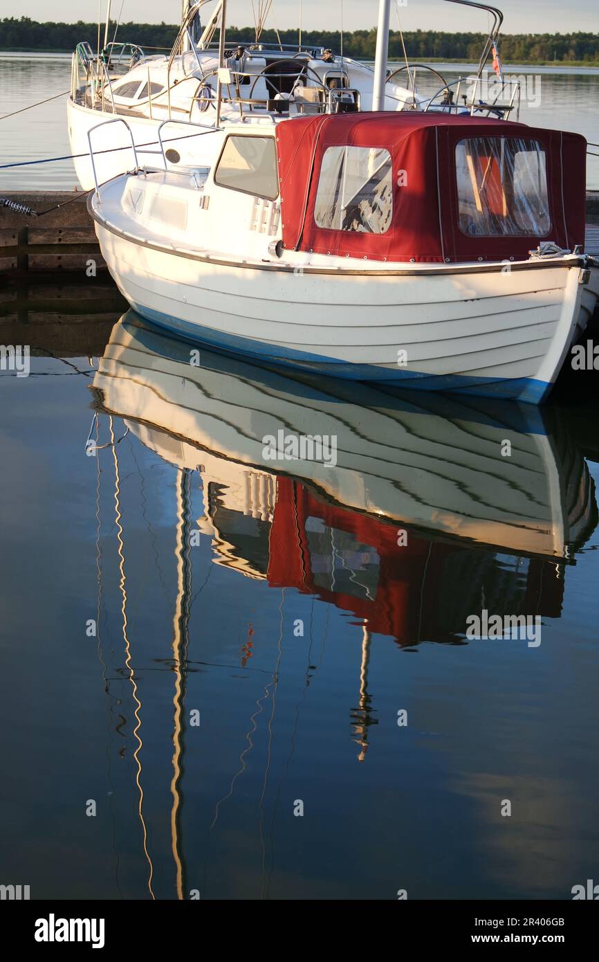 Boat reflected in water Stock Photo - Alamy