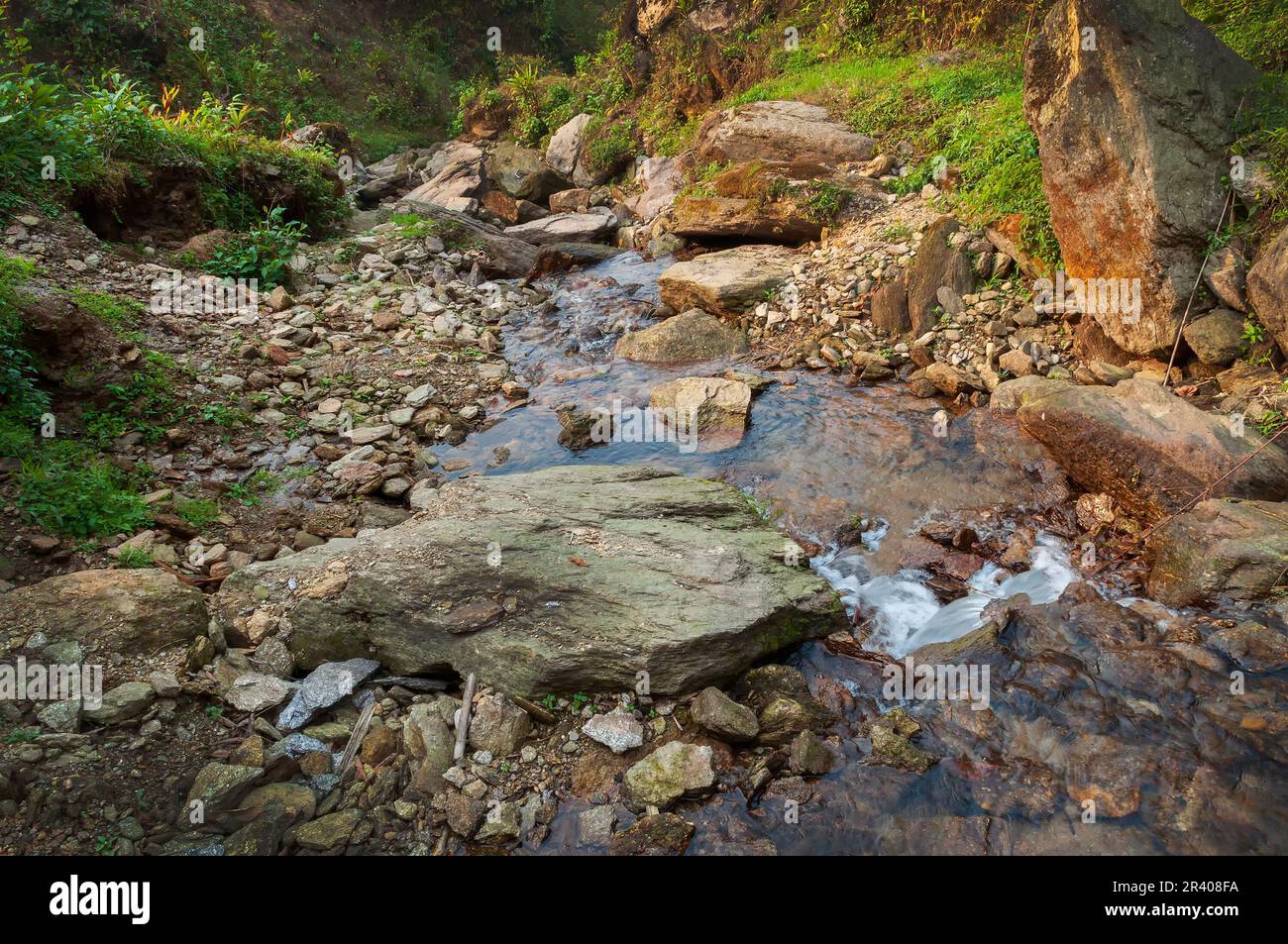 Water flowing downstraem, beautiful waterfall inside Himalayan forest ...