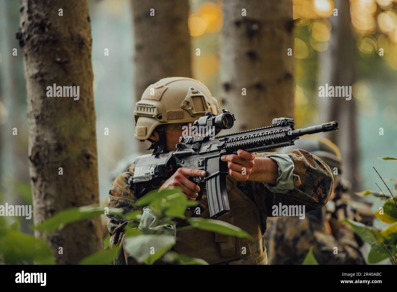 A modern warfare soldier on war duty in dense and dangerous forest areas. Dangerous military ...