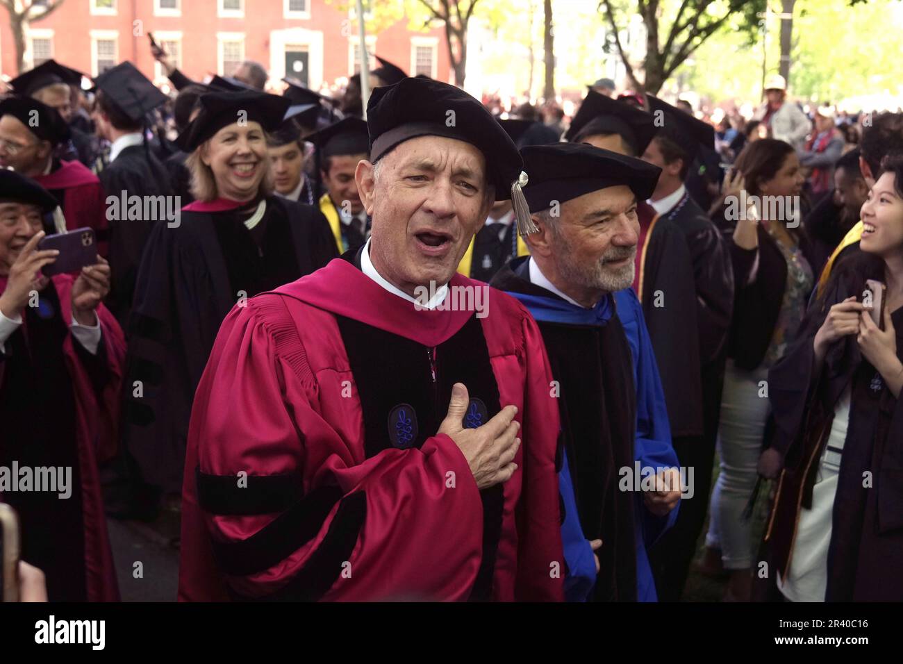 Actor Tom Hanks greets people as he walks in a procession though ...