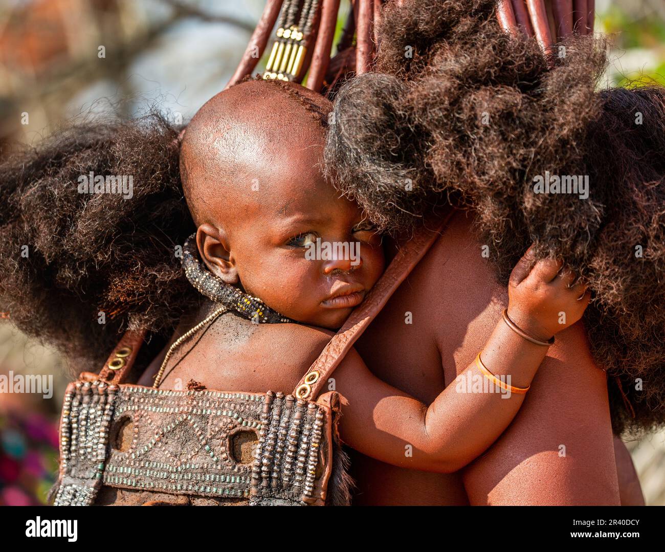 Child of the Himba tribe behind his mother Stock Photo - Alamy