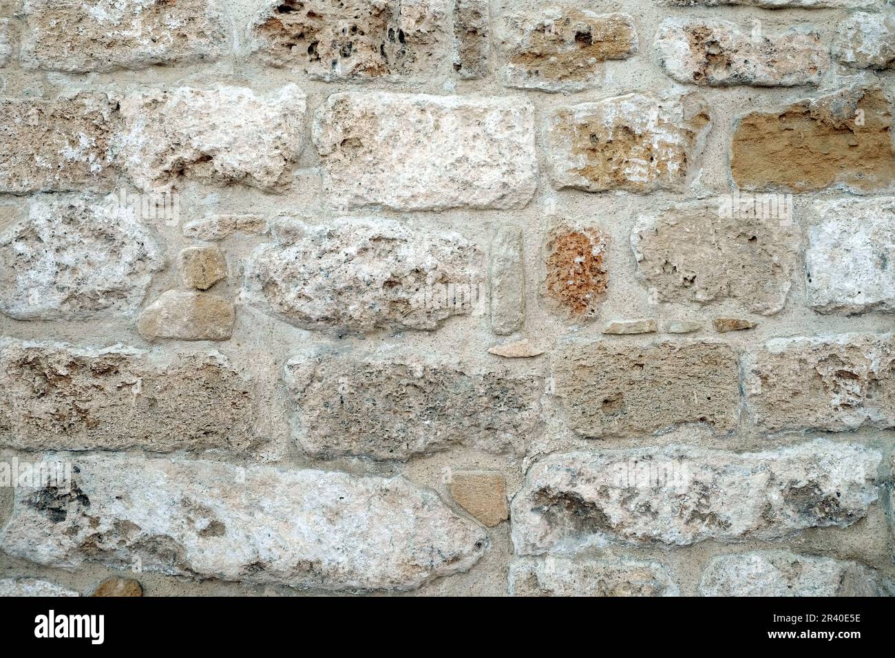 Vintage wall of old natural limestone as background front view close up ...