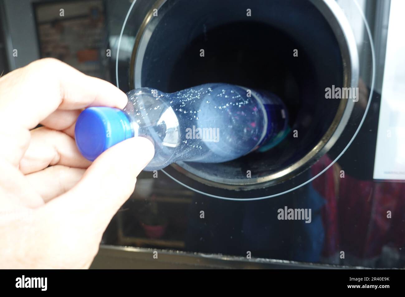 Symbolic image return machine for PET deposit bottles - man's hand ...