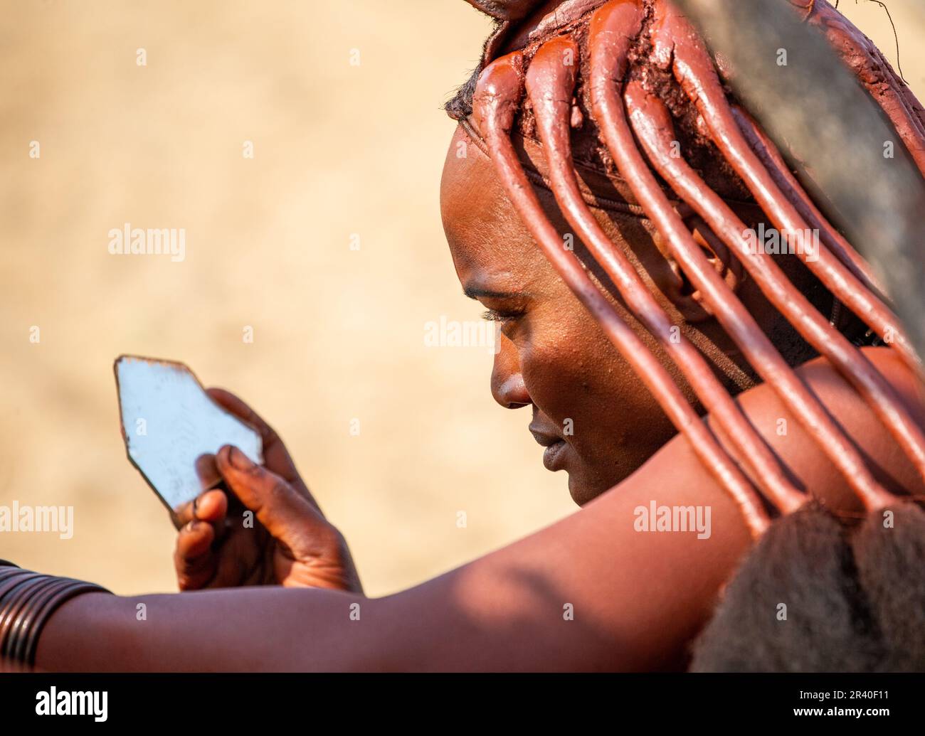 Portrait of a Himba tribe woman with a mirror Stock Photo - Alamy