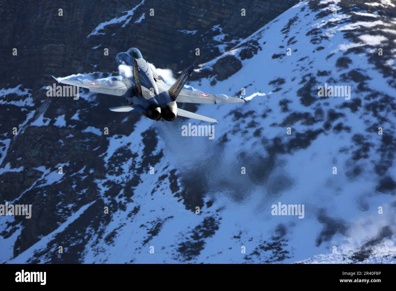 An F/A-18C Hornet jet fighter of the Swiss Air Force over a snow ...