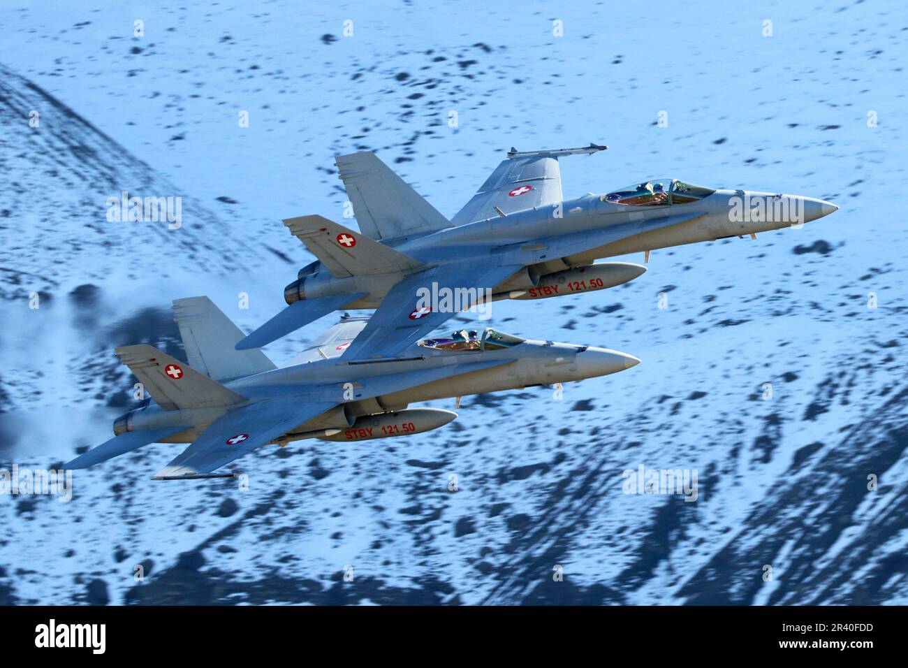 F/A-18C Hornet jet fighters of the Swiss Air Force flying over a snow ...