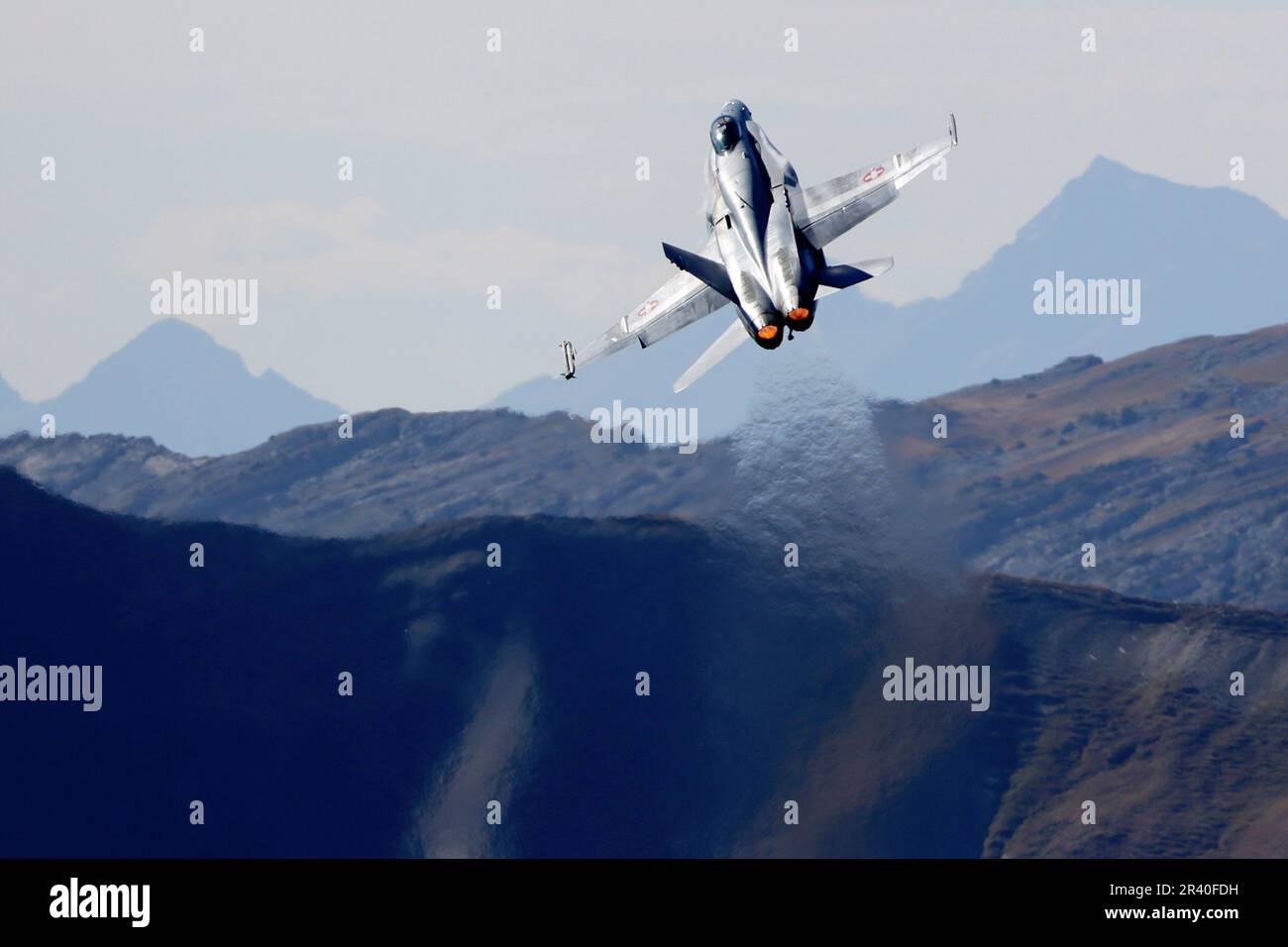 An F/A-18C Hornet jet fighter of the Swiss Air Force flying over Axalp ...