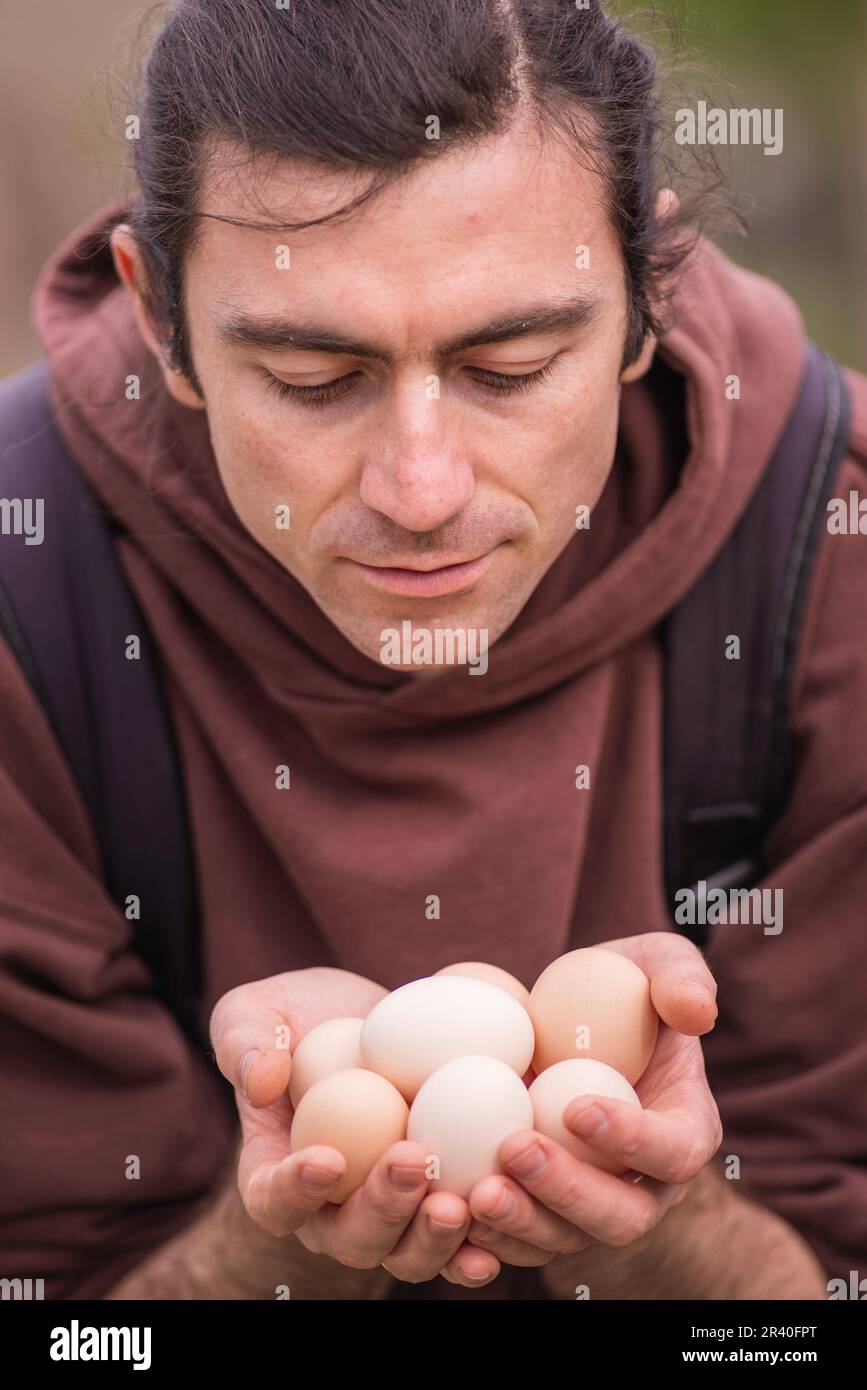 Happy young man Farmer portrait holding hands eggs fresh organic ...