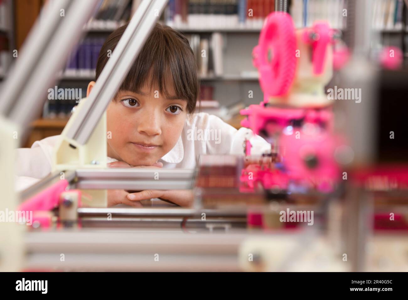 Young girl watching 3D printer Stock Photo - Alamy