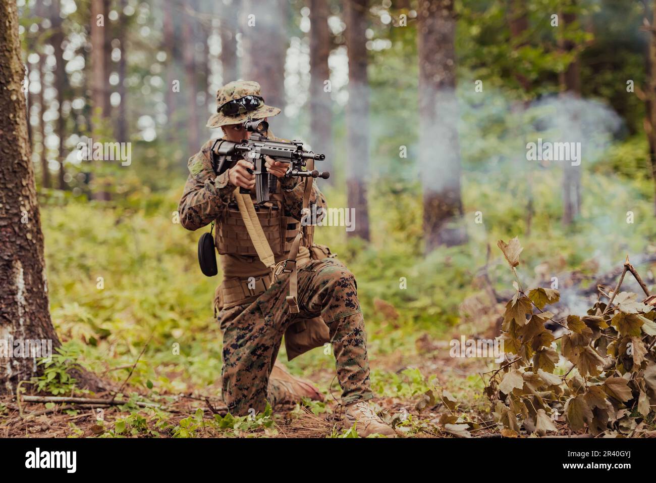 A modern warfare soldier on war duty in dense and dangerous forest areas. Dangerous military ...