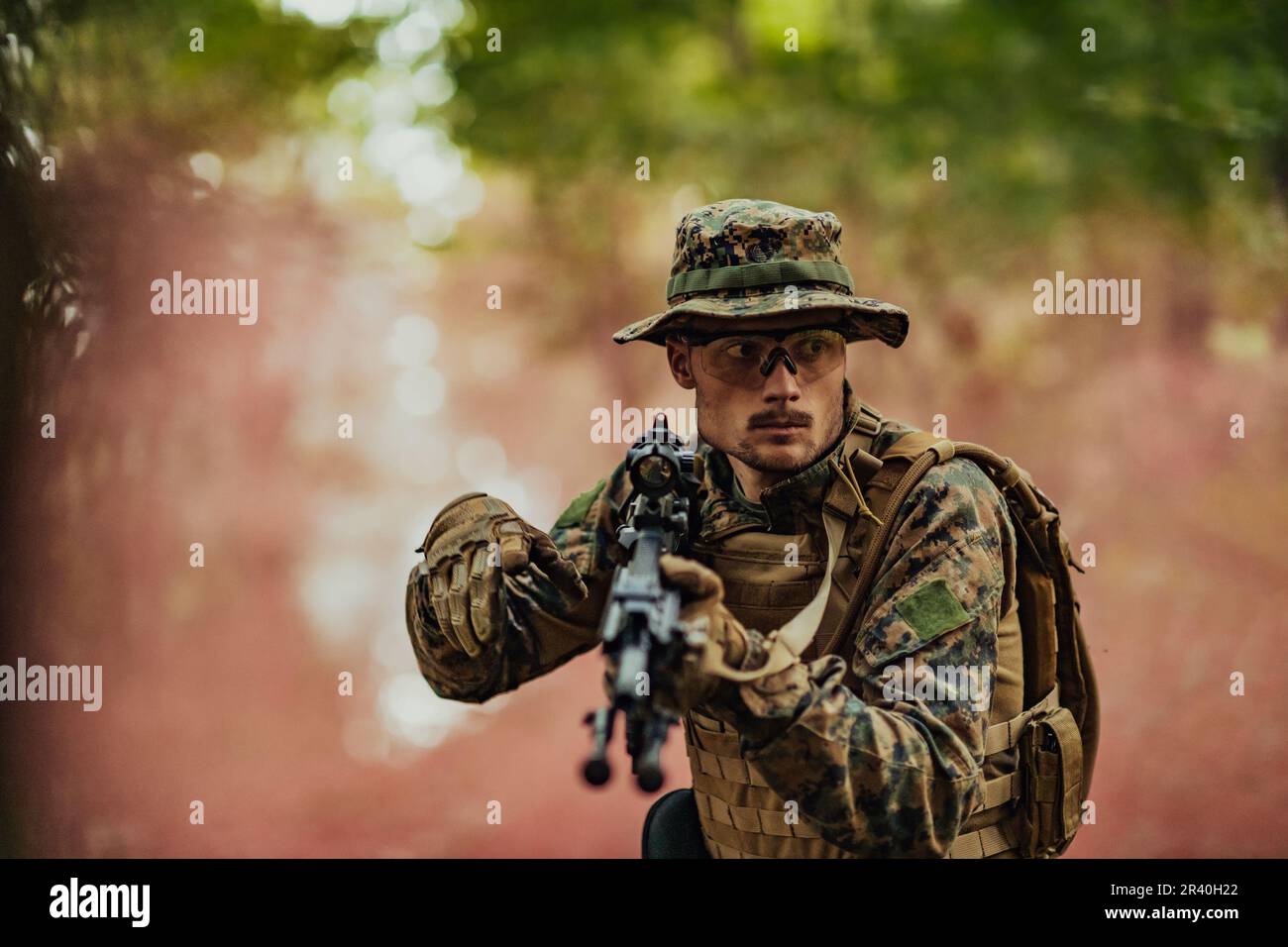 A modern warfare soldier on war duty in dense and dangerous forest ...
