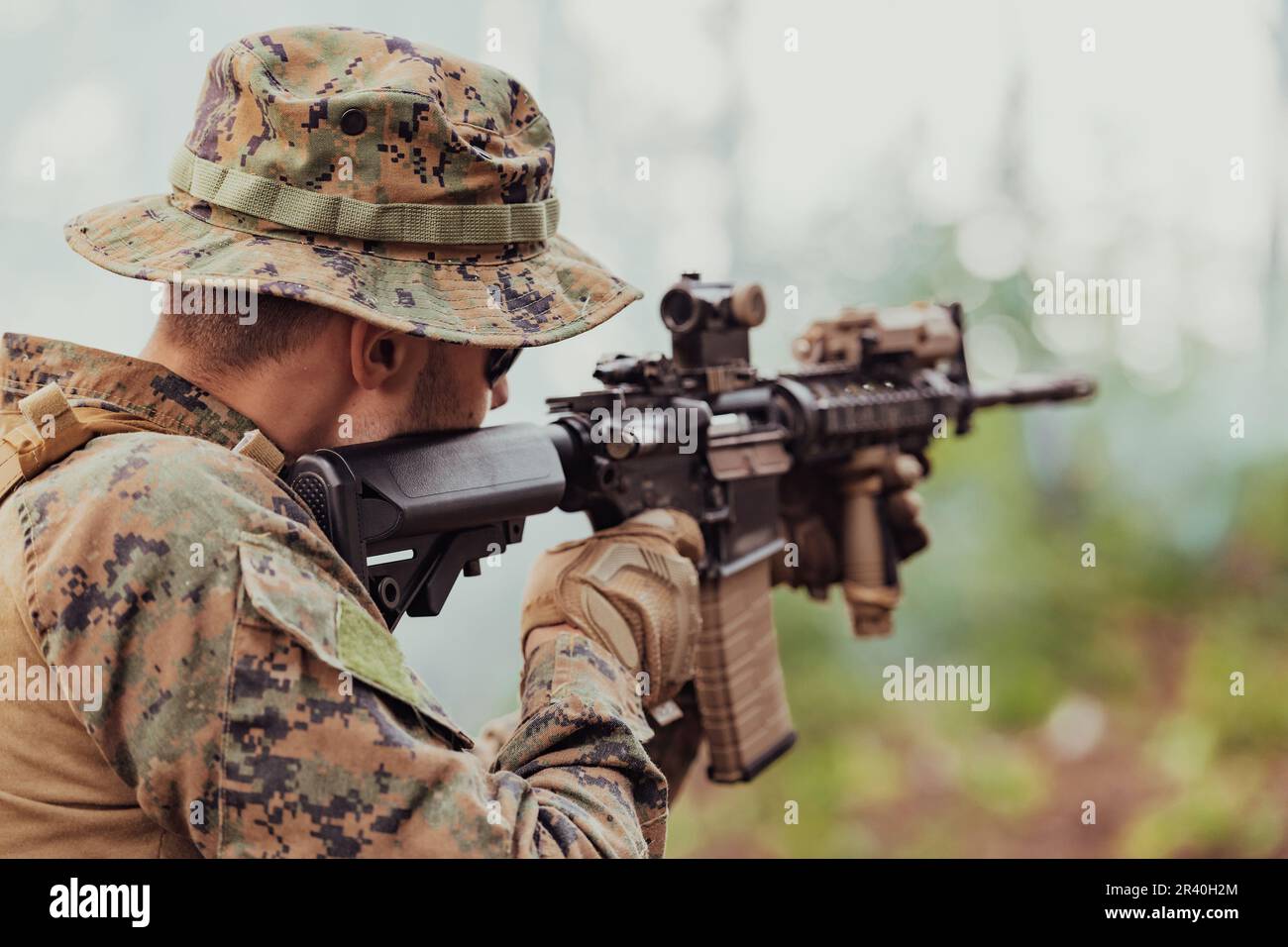 A modern warfare soldier on war duty in dense and dangerous forest ...