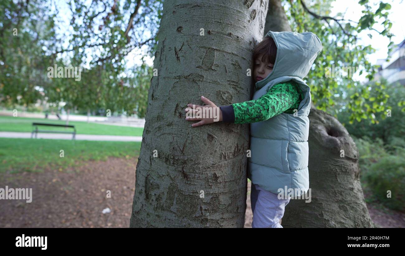 One little boy son hugging tree. Environmentally friendly child ...